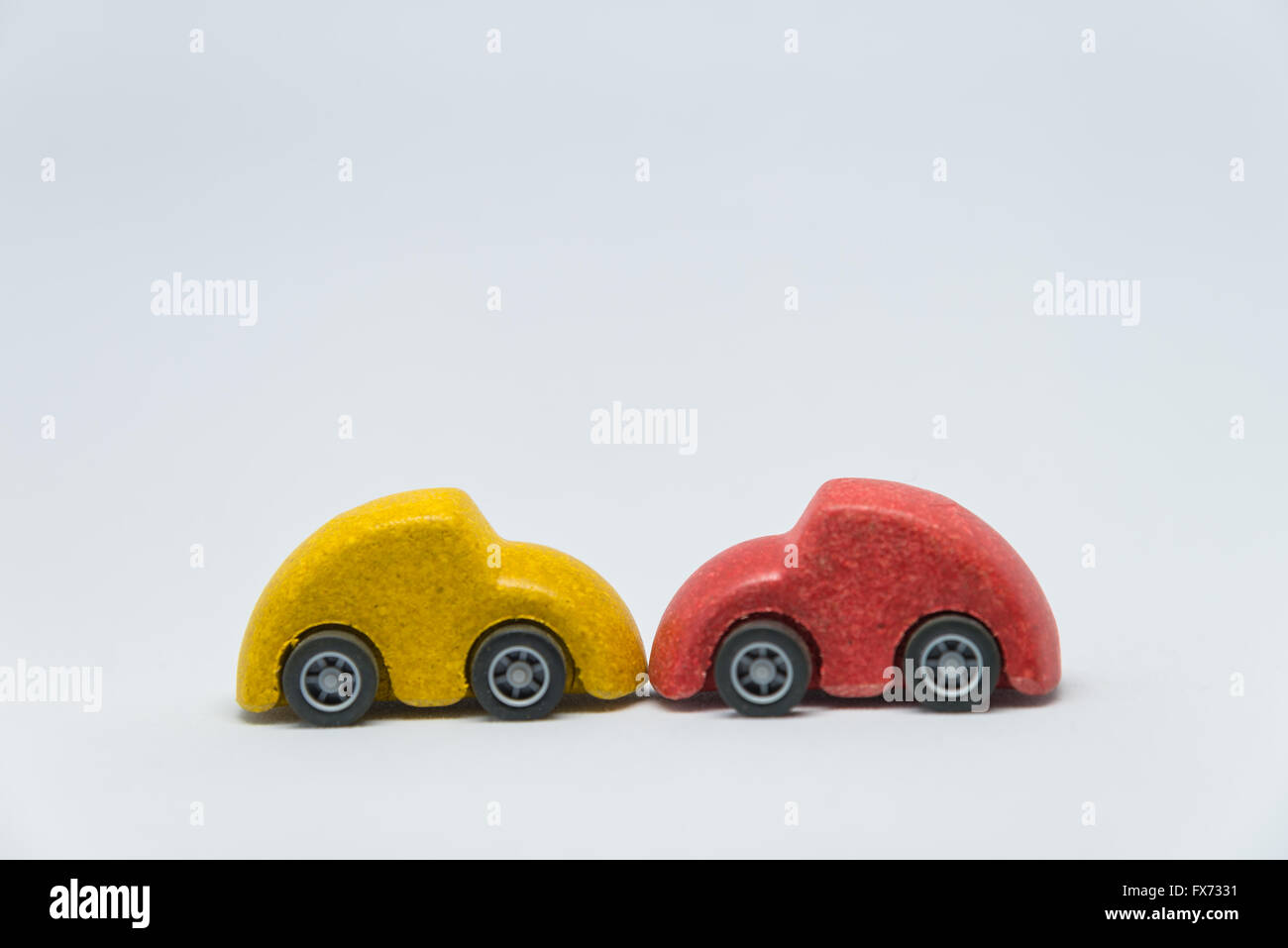 Yellow toy car crashed red toy car accident with white background Stock ...