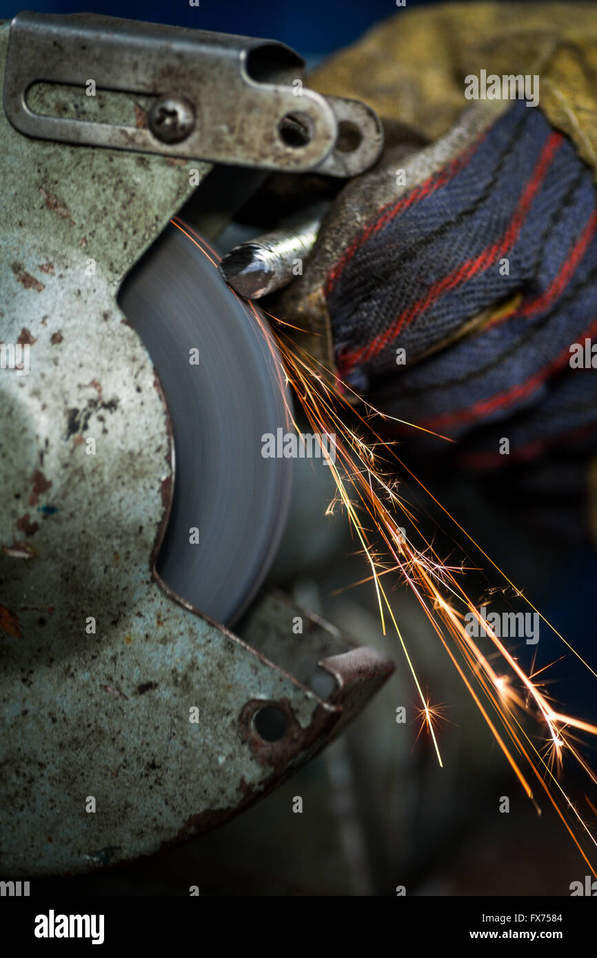 Color image of a hand polishing at a grinder Stock Photo - Alamy