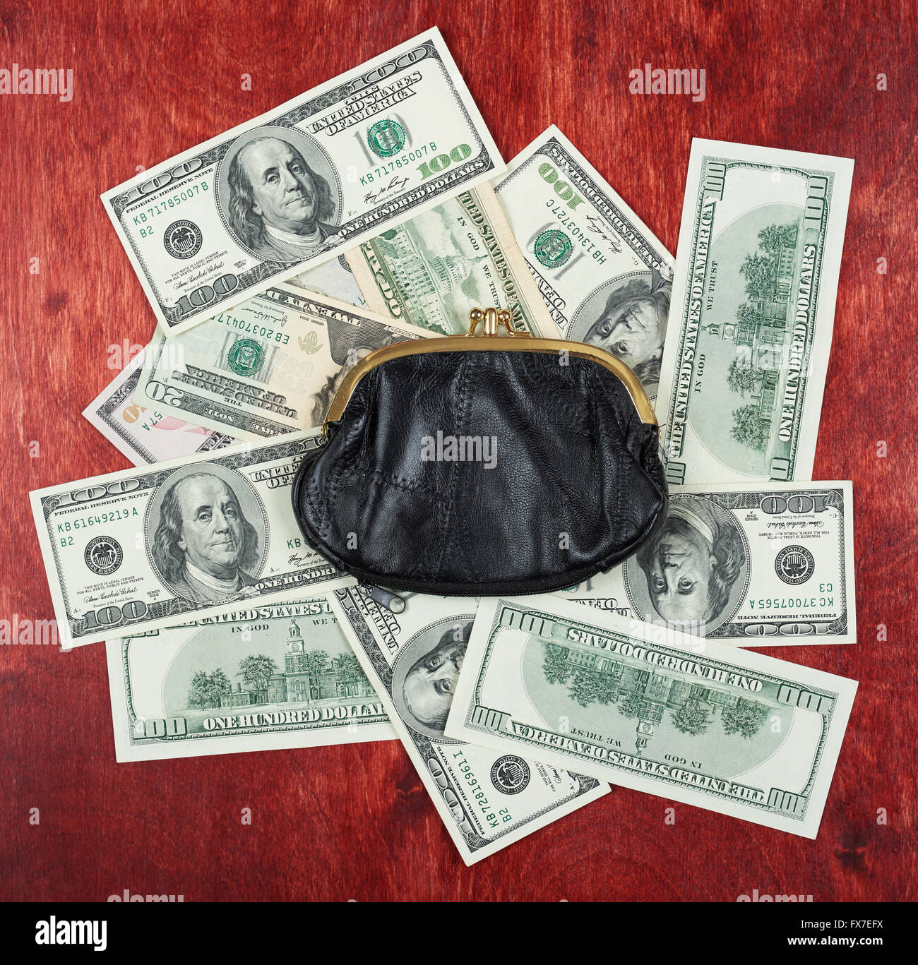 Purse placed on center of money dollar and wood background, business ...