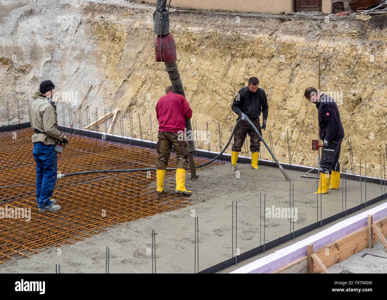 Construction worker during concrete pouring work at the construction ...