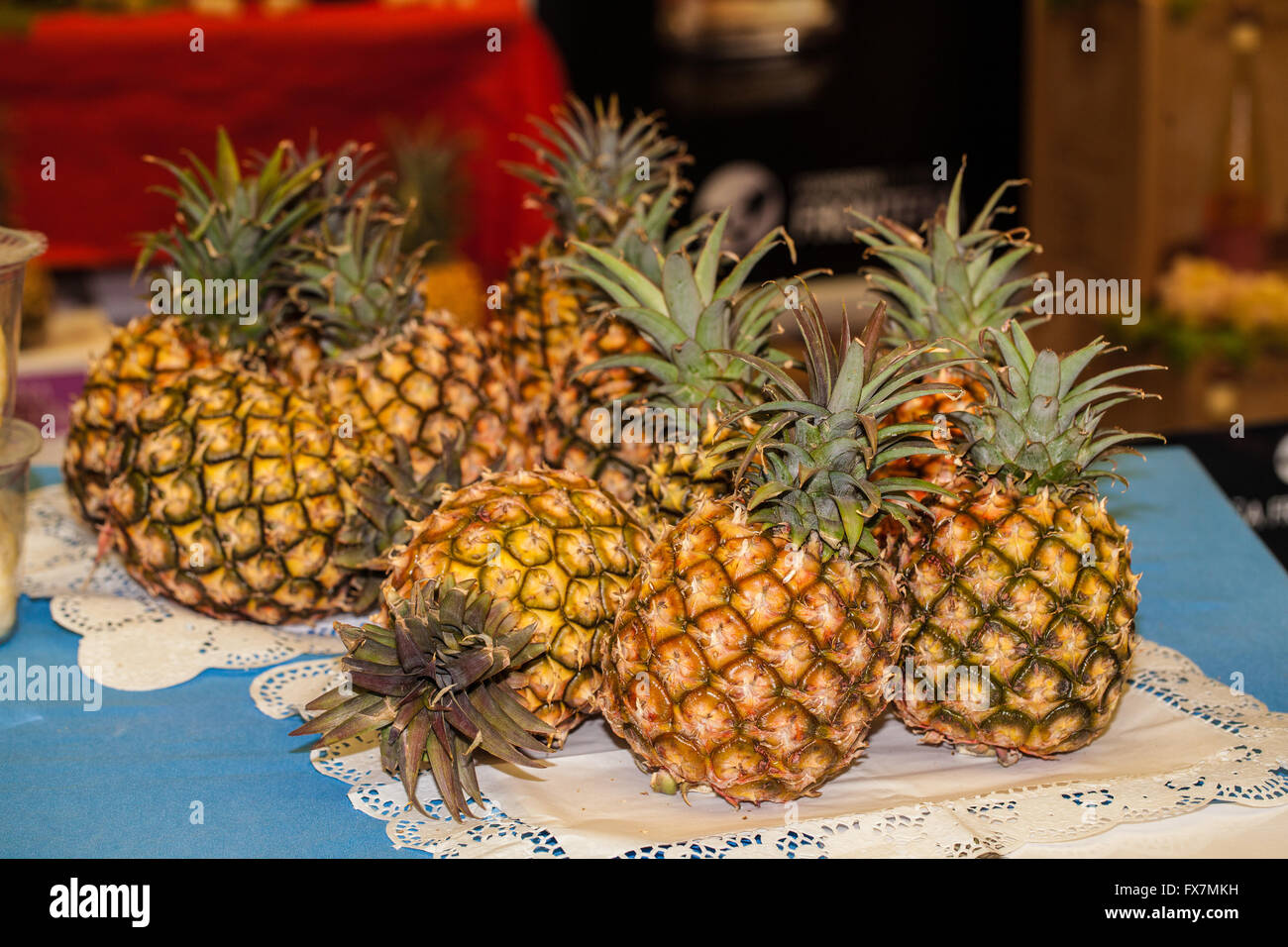 Raw pineapples on a table Stock Photo - Alamy