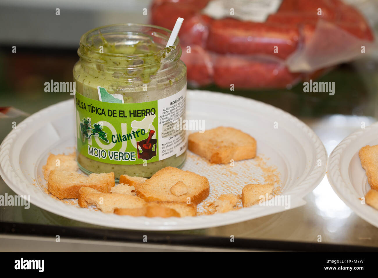 canarian green mojo sauce open jar on a white dish with bread crumbs ...