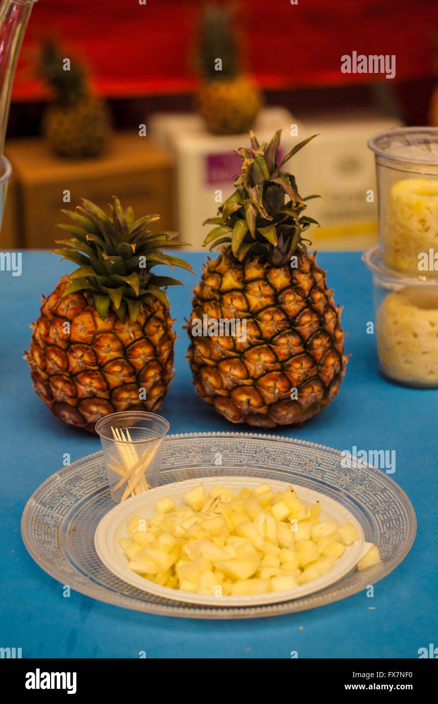 two raw whole pineapples with a dish Stock Photo - Alamy