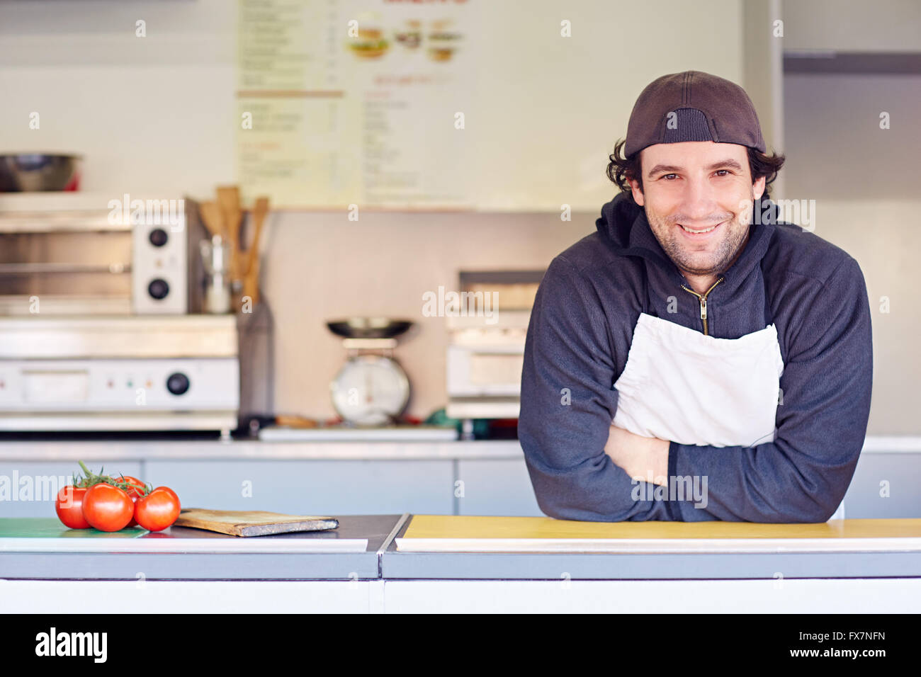 Friendly entrepeneur in his clean takeaway food stall Stock Photo - Alamy