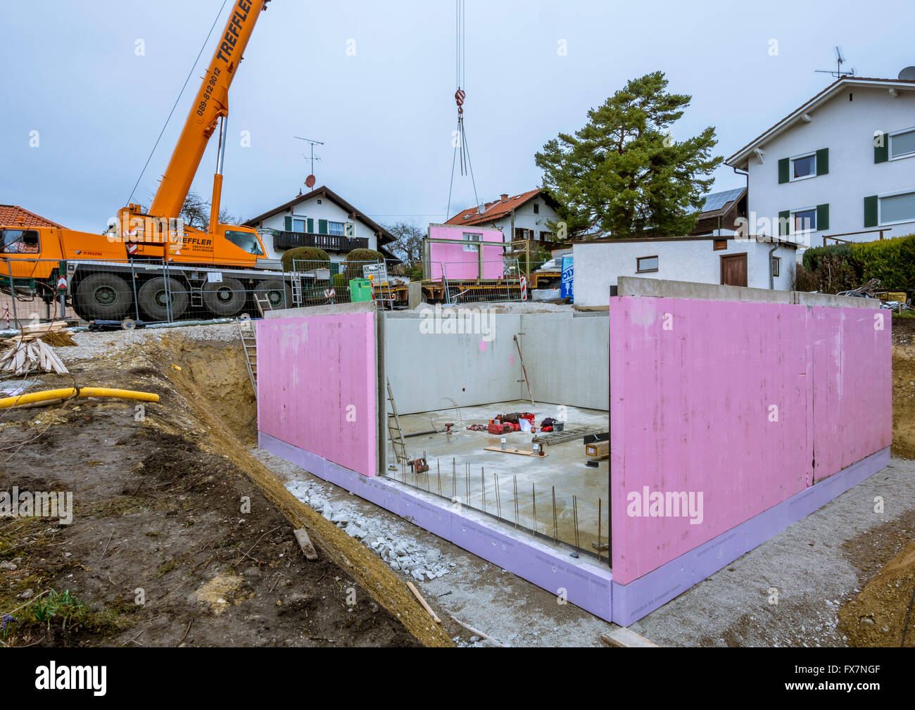 Prefabricated house, workers in setting up the basement walls on ...