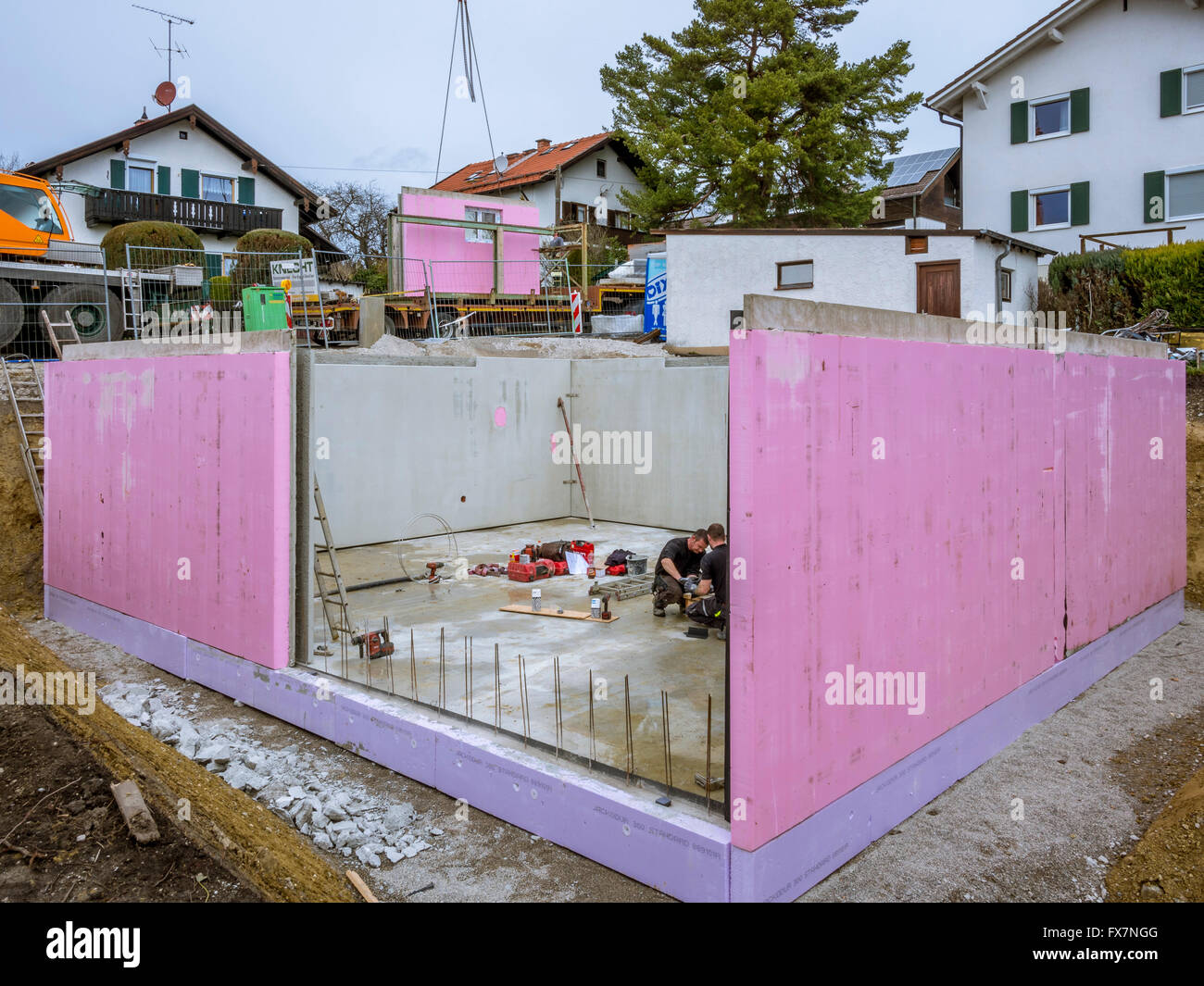 Prefabricated house, workers in setting up the basement walls on ...