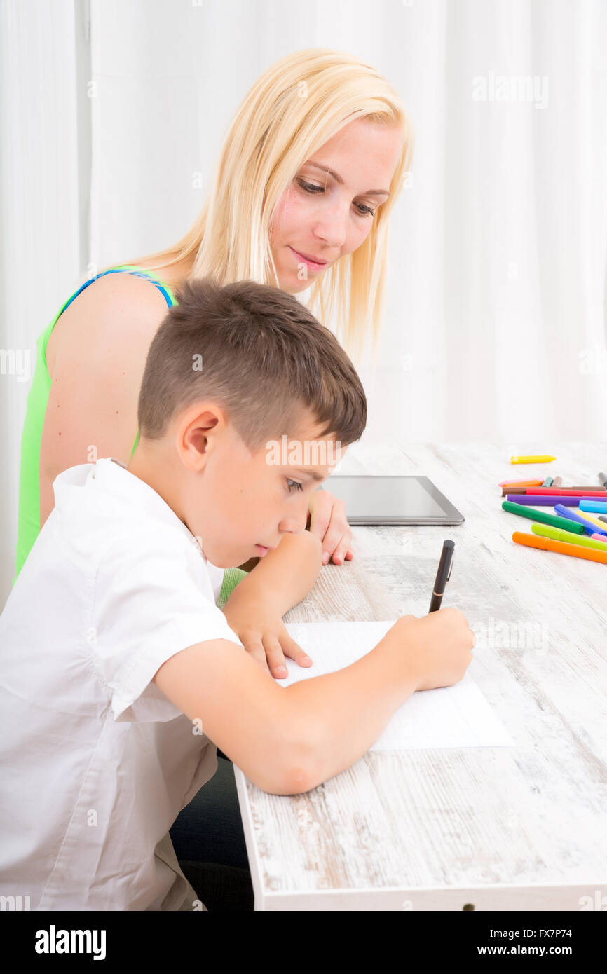 A mother helping his son with his homework Stock Photo - Alamy