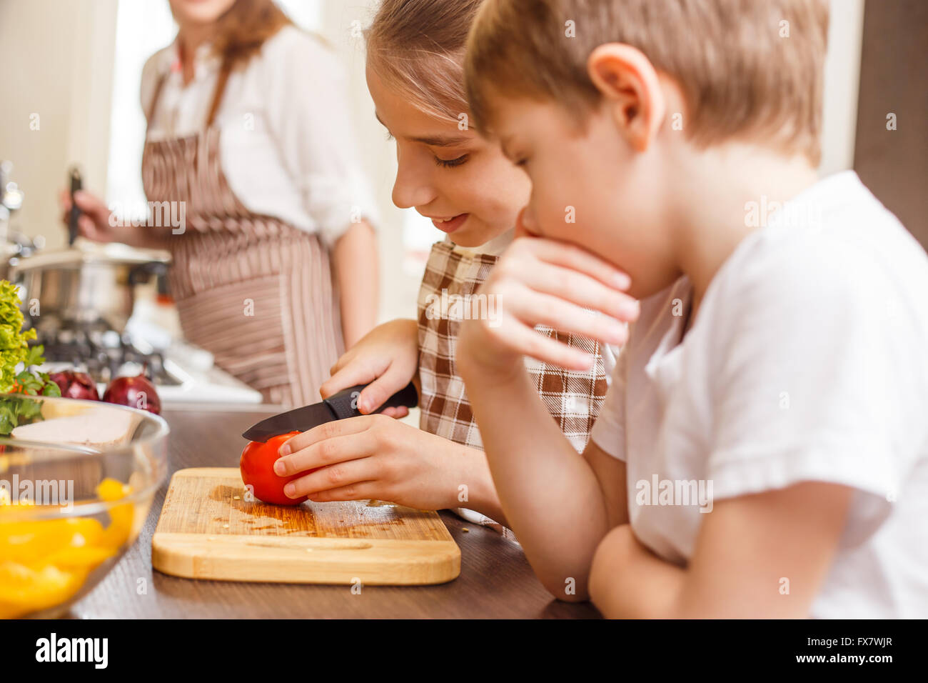 Fun family cooking background. Children preparing salad at the kitchen ...
