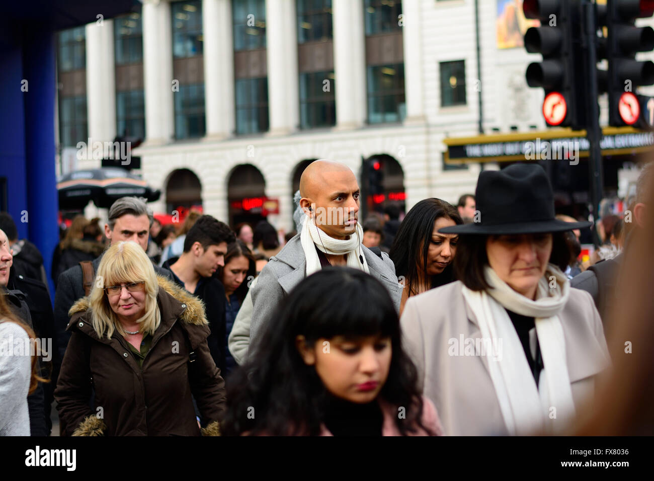 Tall bald Asian man crossing a crowded street in London Stock Photo - Alamy