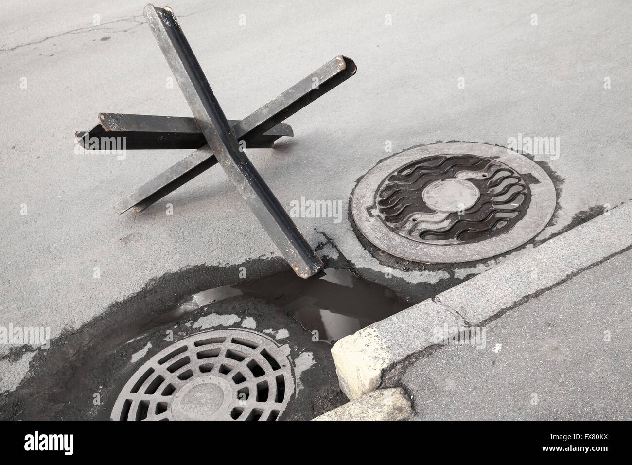 Black steel street barrier in shape of anti-tank Czech hedgehog ...