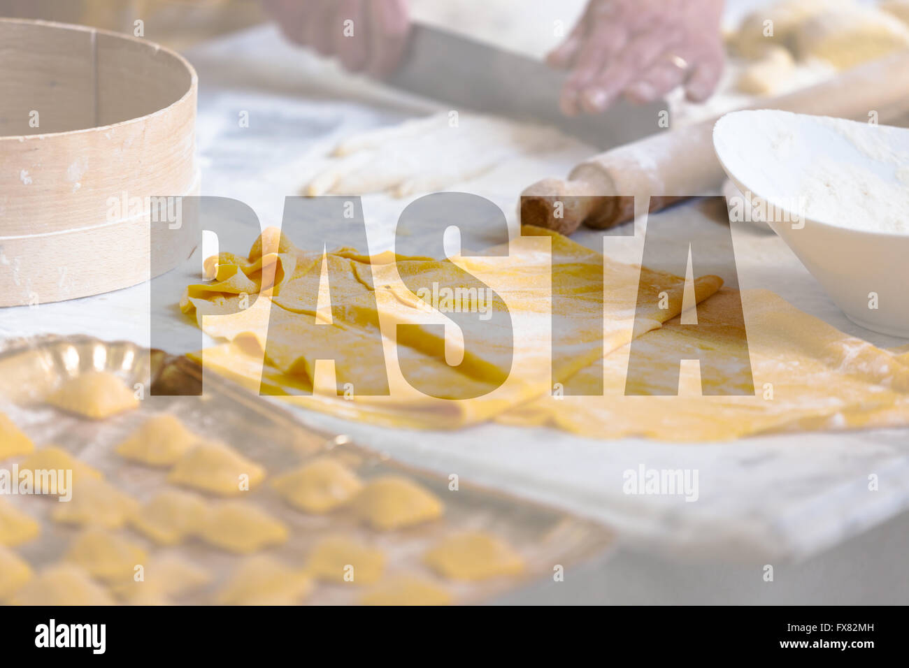 Pasta, written on a background of a picture with Hands of a chef ...