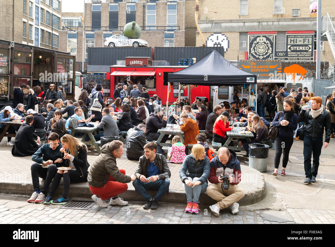 People sitting in the street, Brick Lane Sunday Upmarket, Spitalfields ...