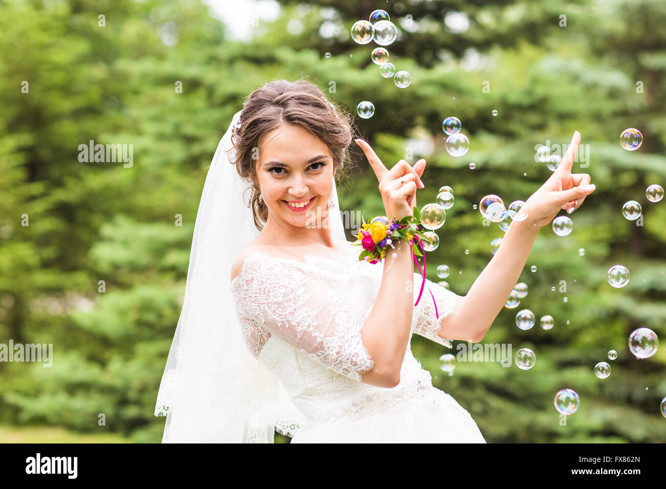Young bride play with soap-bubble and joy smile Stock Photo - Alamy