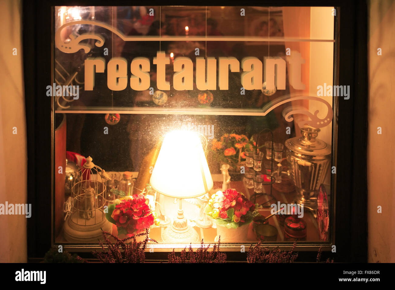 Russian restaurant window with lighting lamp at night Stock Photo - Alamy