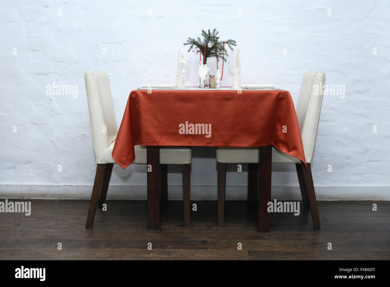 Empty table for two and chairs against white wall in restaurant Stock ...