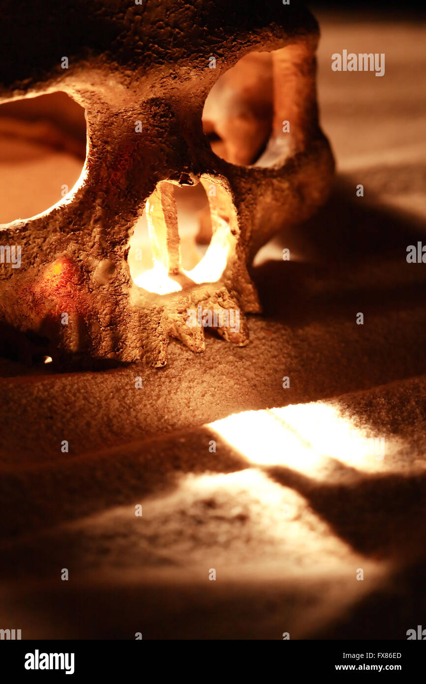Closeup of human skull on sand under beam of light Stock Photo - Alamy