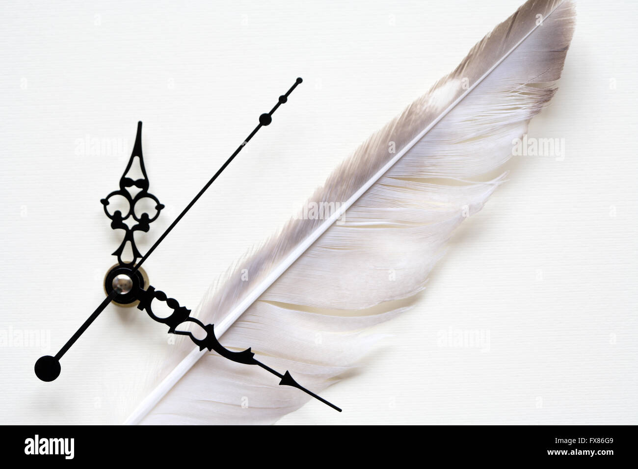 Art concept. Closeup of quill near clock face on paper background Stock ...