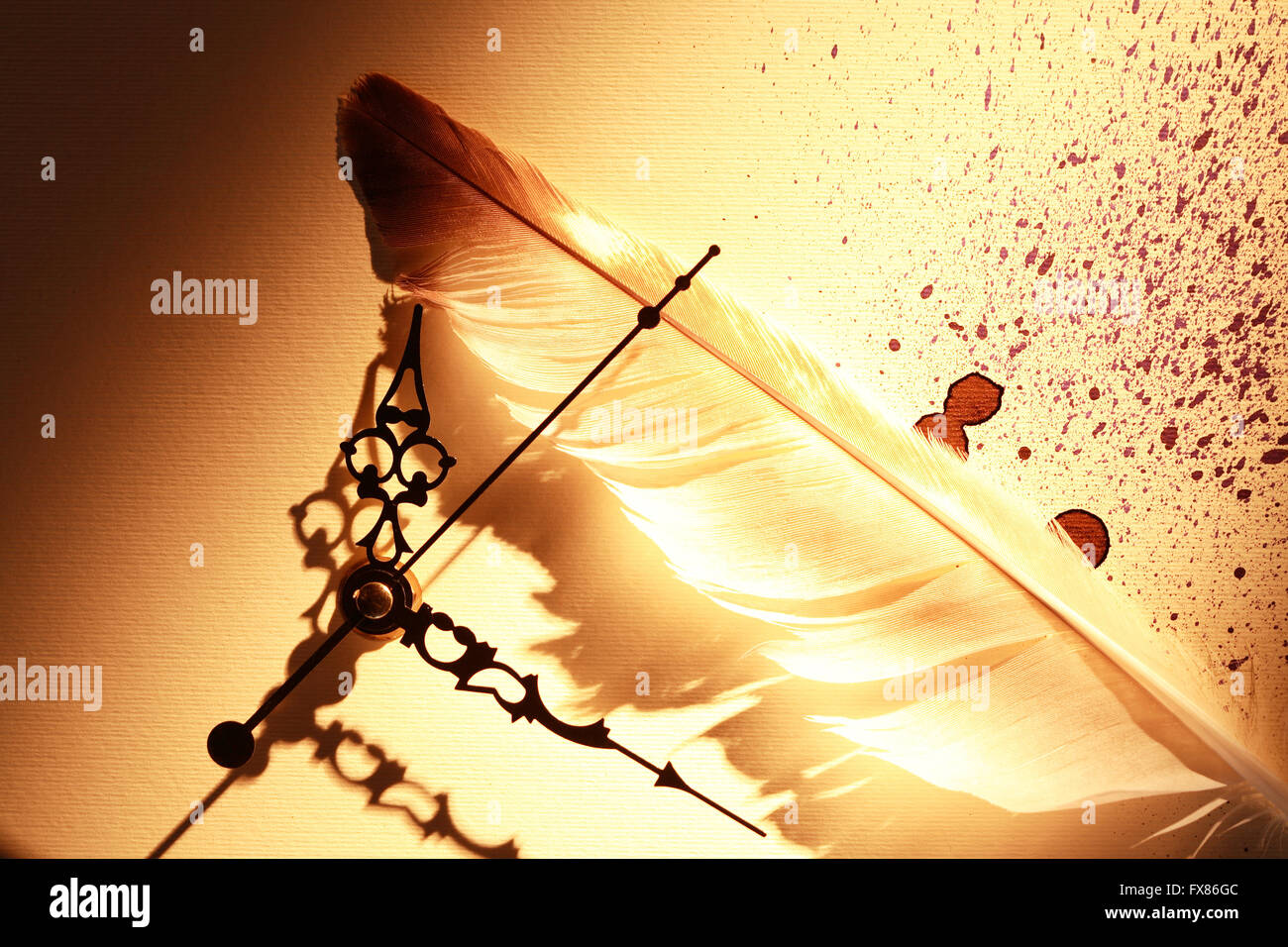 Art symbol. Closeup of quill near clock face on paper background with ...