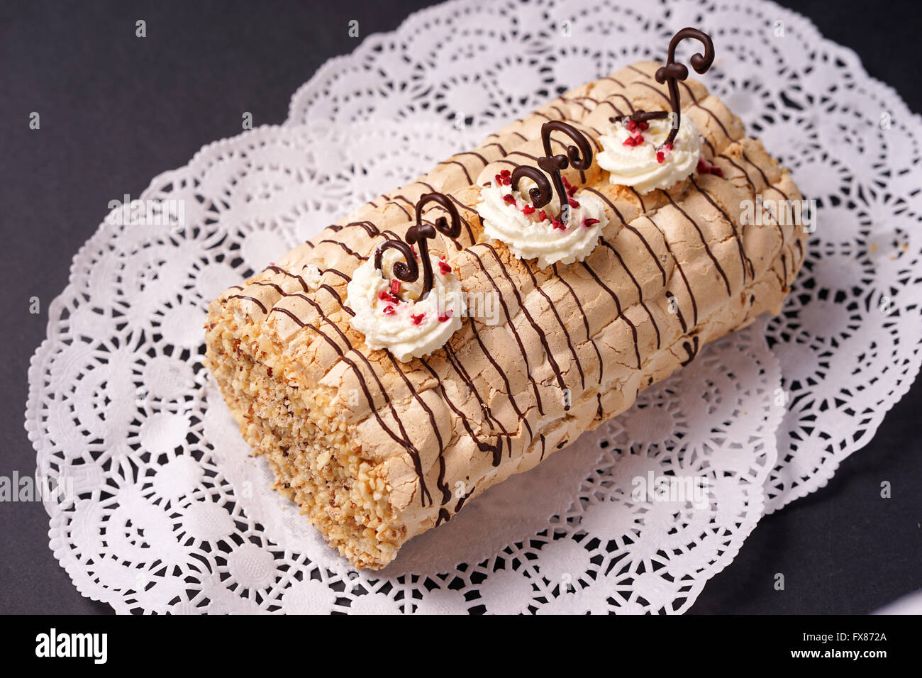 pastry biscuit roulade with whipped cream and chocolate scrolls ready ...