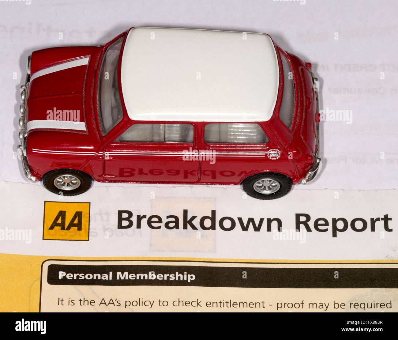 A miniature red mini cooper in front of a AA breakdown report Stock ...