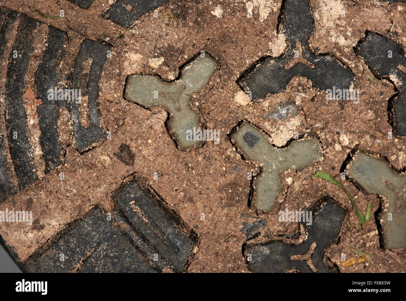 Dried mud on the underside of a walking boots close up Stock Photo - Alamy