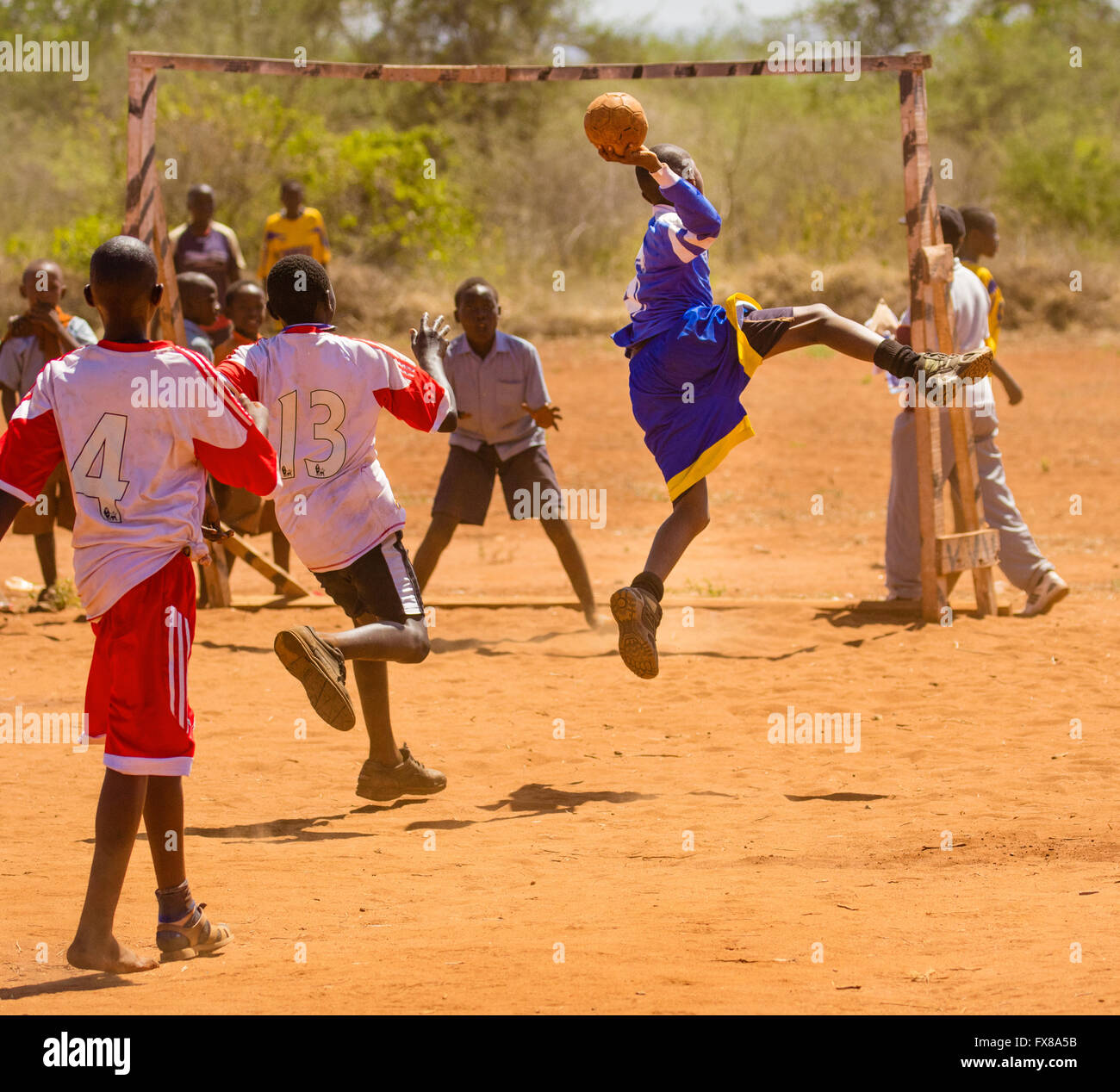 A boy about to score a goal in a game of handball in a school near Voi ...