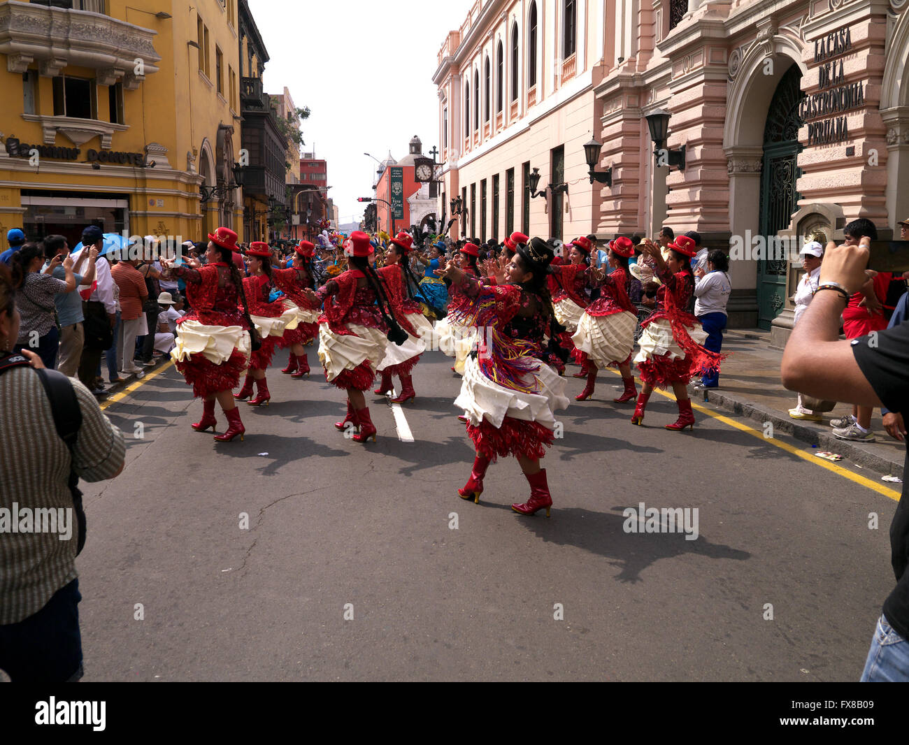 People in traditional Peruvian dress dancing in the street in Lima ...