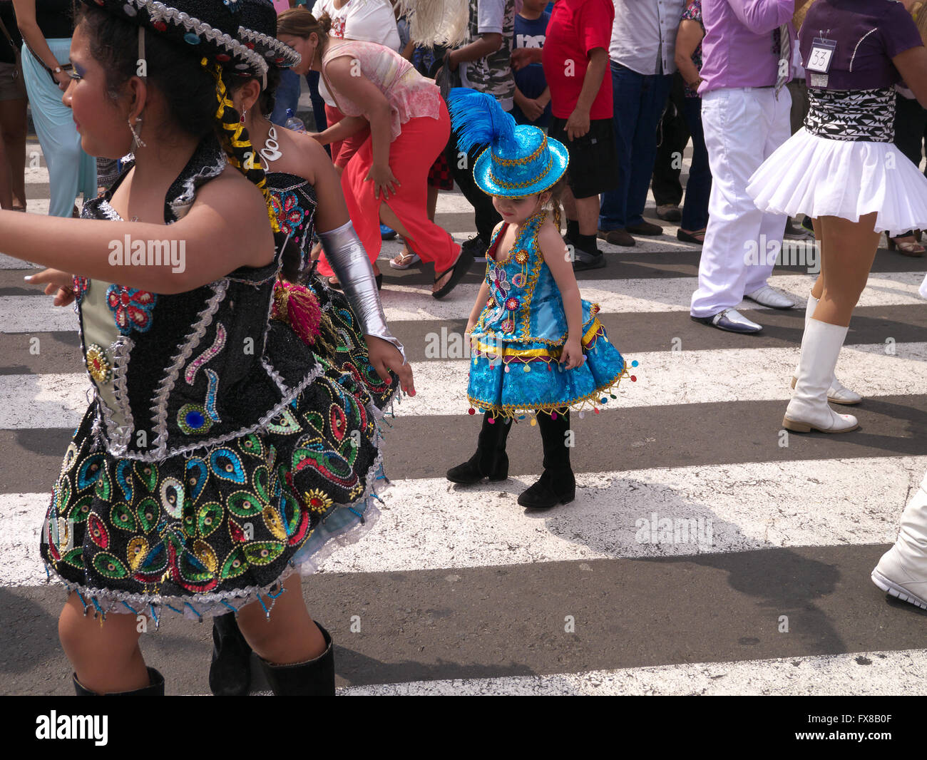 Child in traditional Peruvian dress dancing in the street in Lima Stock ...