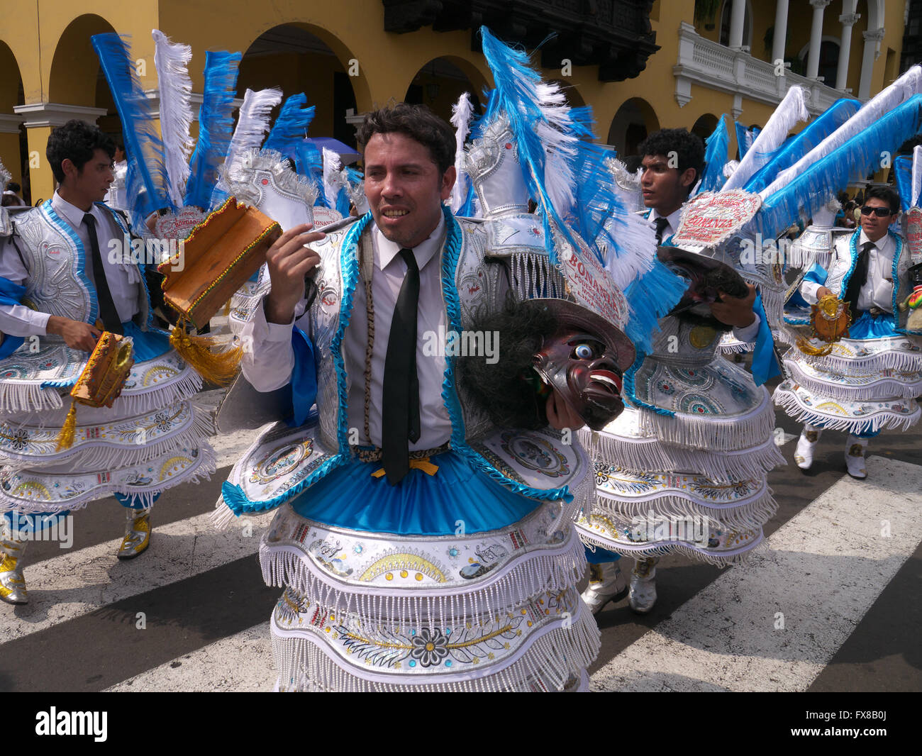 Men and boys in traditional Peruvian dress dancing in the street in ...