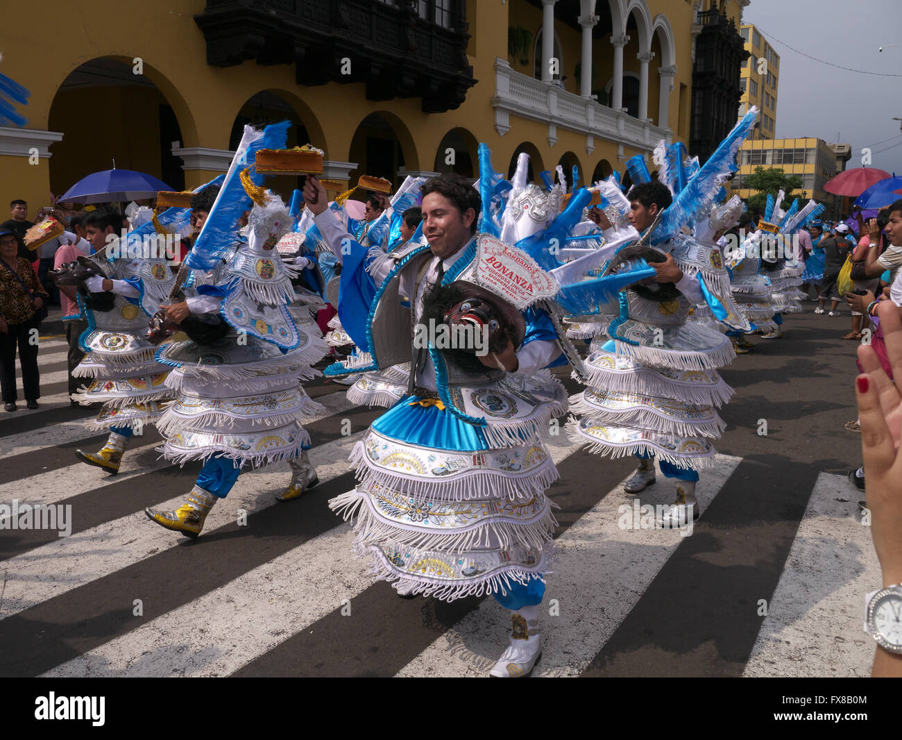 Men and boys in traditional Peruvian dress dancing in the street in ...