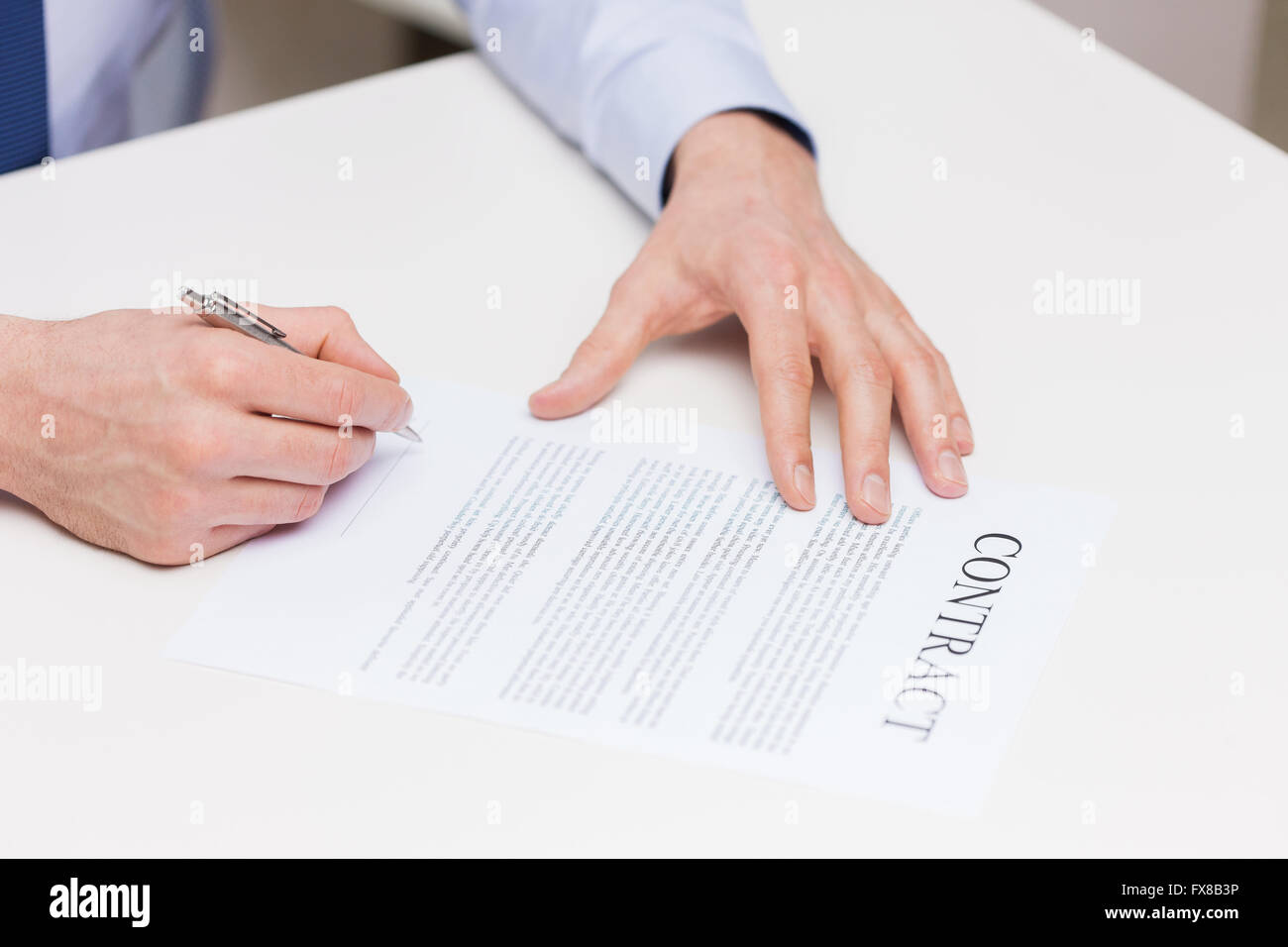 close up of male hands signing contract document Stock Photo - Alamy