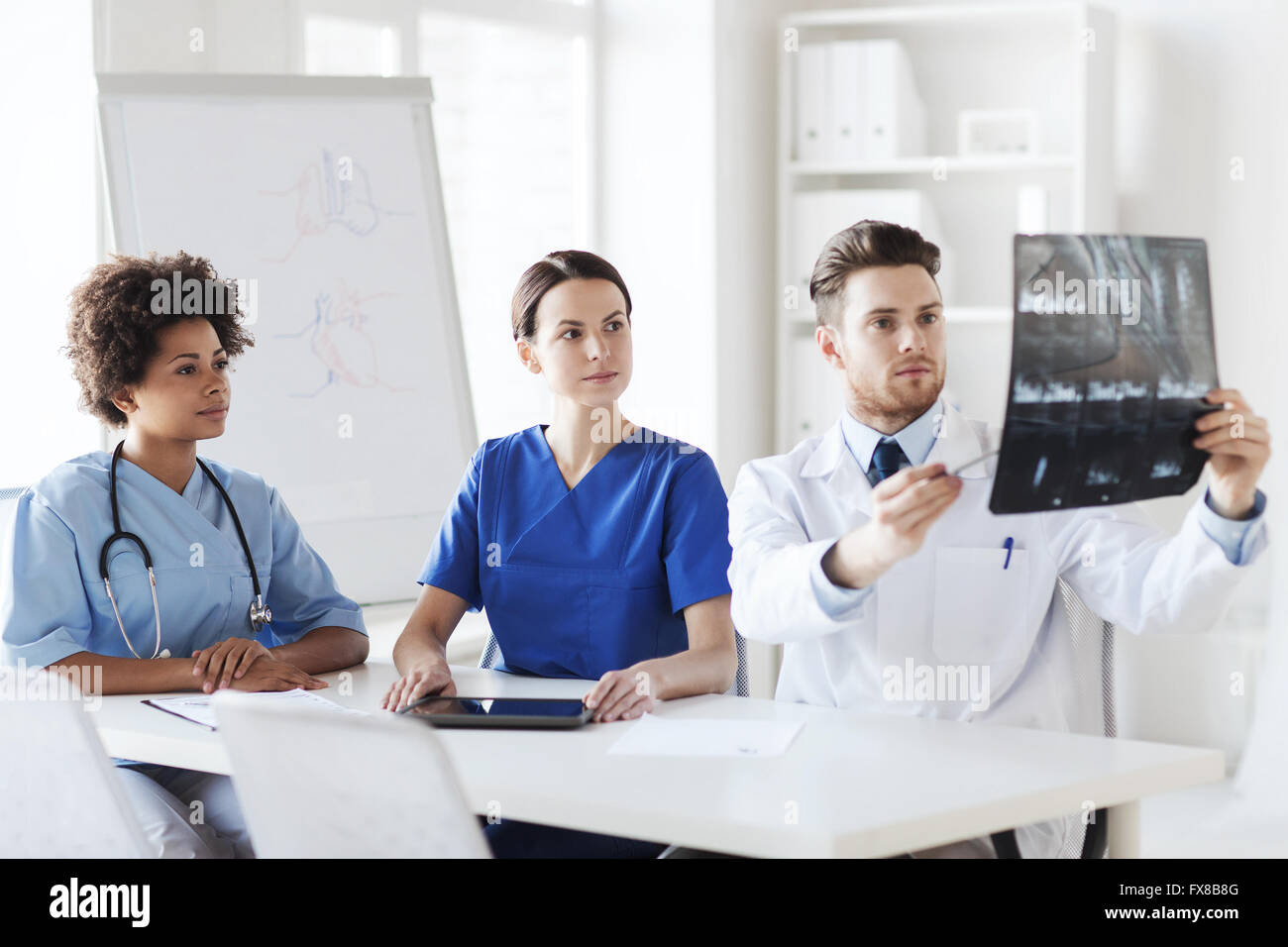 group of doctors discussing x-ray image Stock Photo - Alamy