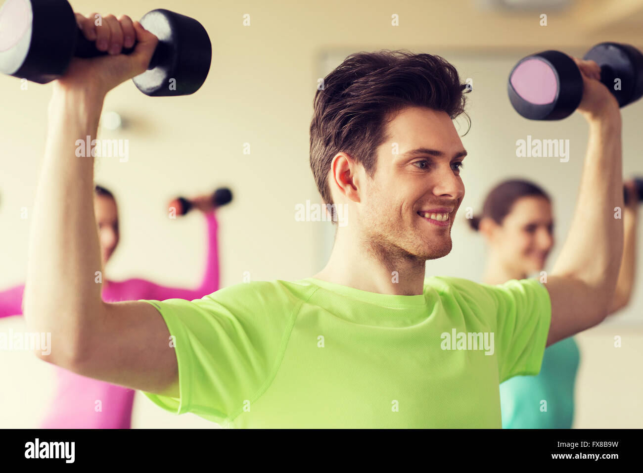 group of smiling people working out with dumbbells Stock Photo - Alamy