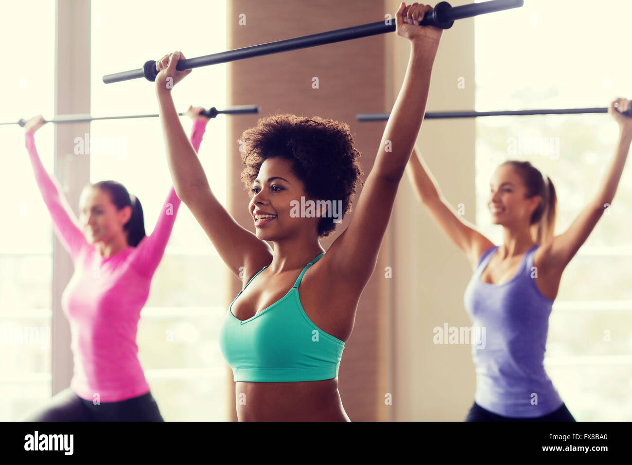 group of people exercising with bars in gym Stock Photo - Alamy