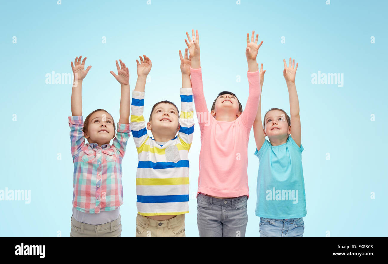 happy children celebrating victory over blue Stock Photo - Alamy