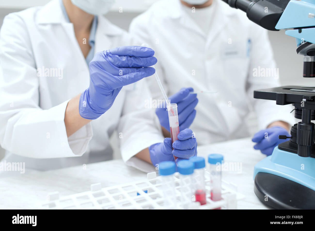 close up of scientists filling test tube in lab Stock Photo - Alamy
