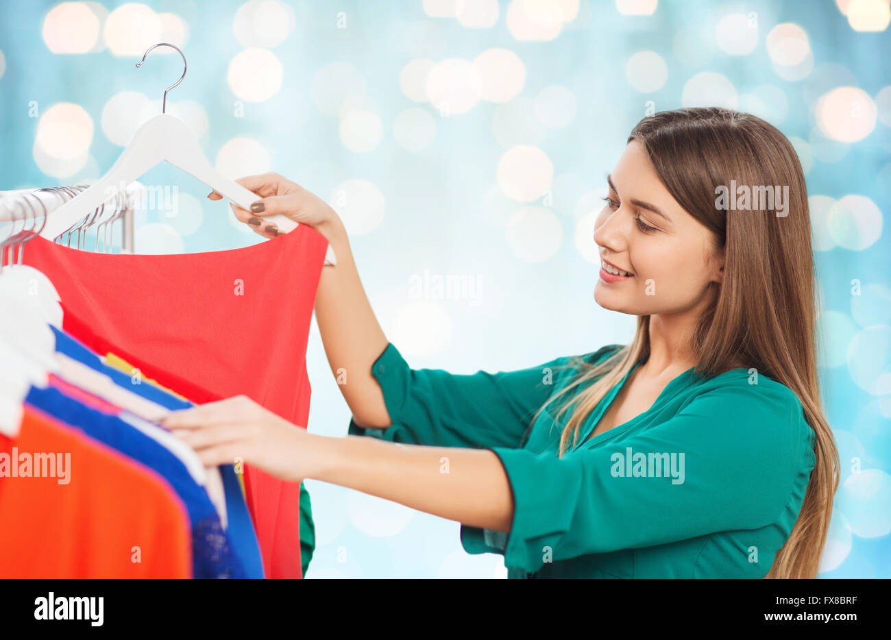 happy woman choosing clothes at wardrobe Stock Photo - Alamy
