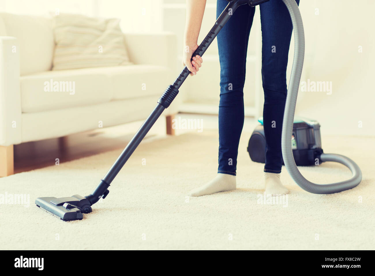 close up of woman legs with vacuum cleaner at home Stock Photo - Alamy