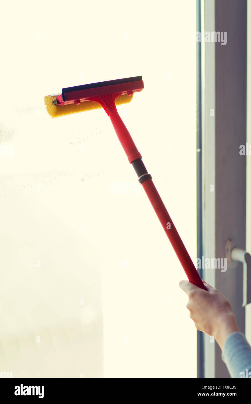 close up of hand cleaning window with sponge Stock Photo - Alamy
