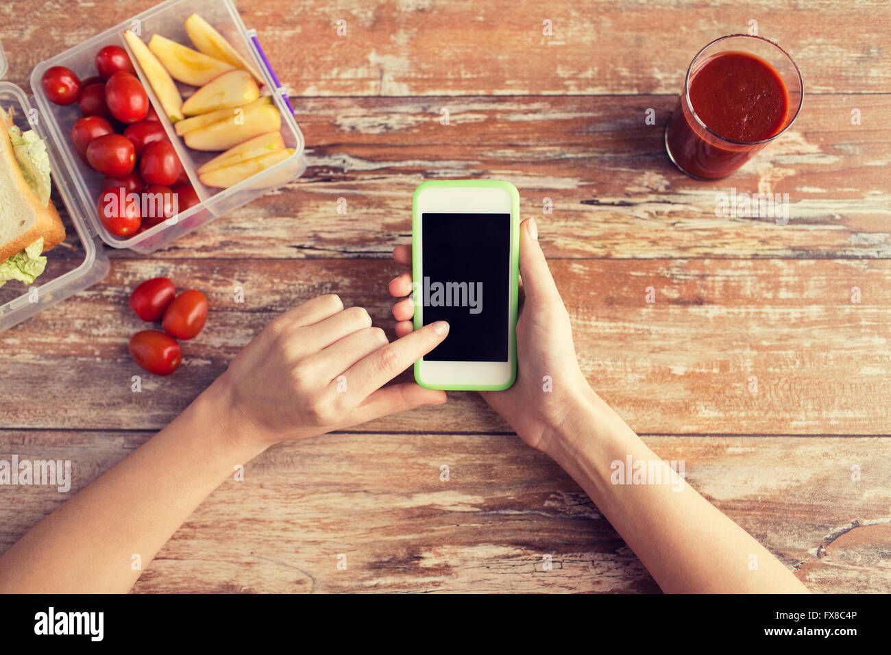 close up of hands with smartphone food on table Stock Photo - Alamy