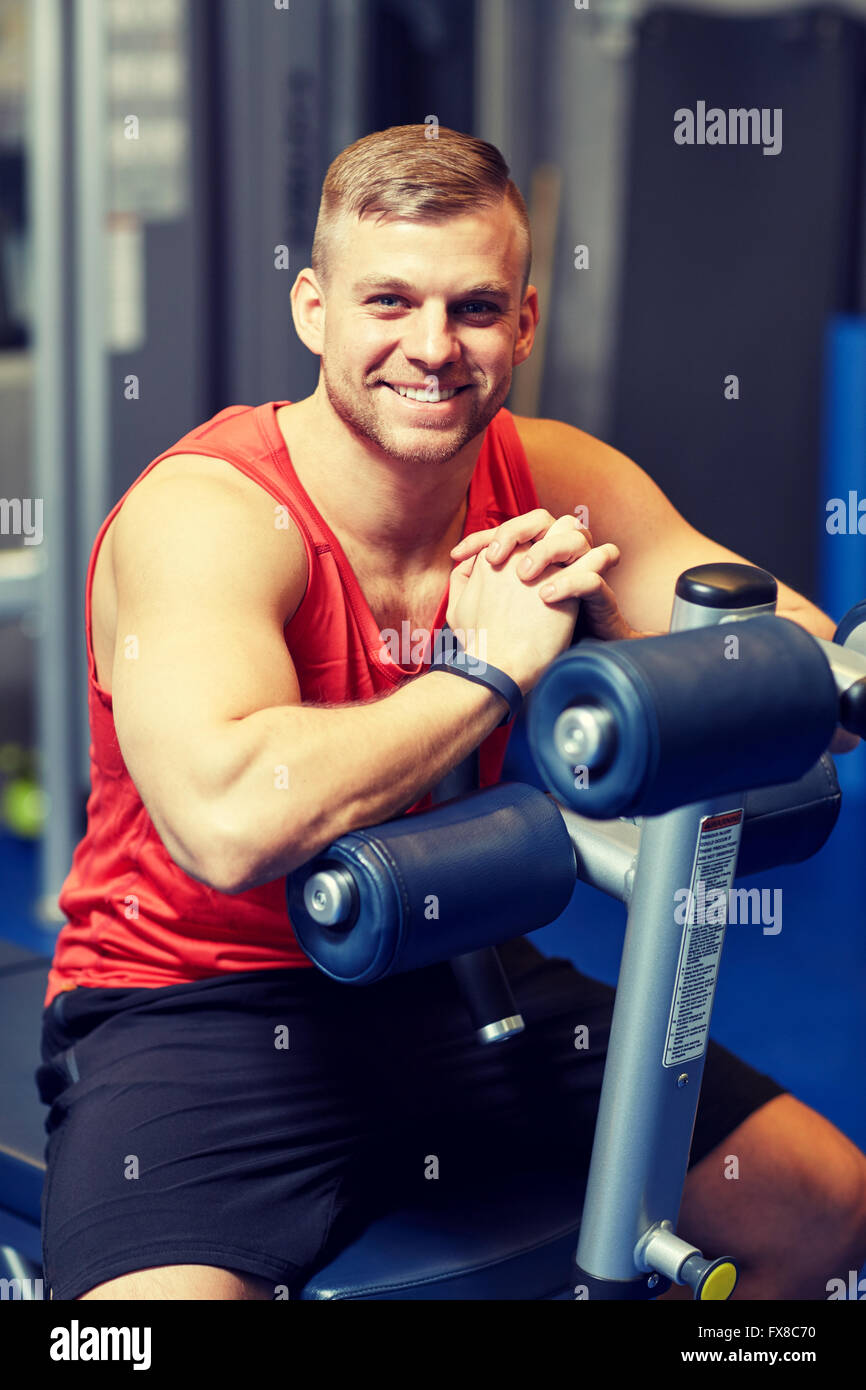 smiling man sitting on exercise bench in gym Stock Photo - Alamy