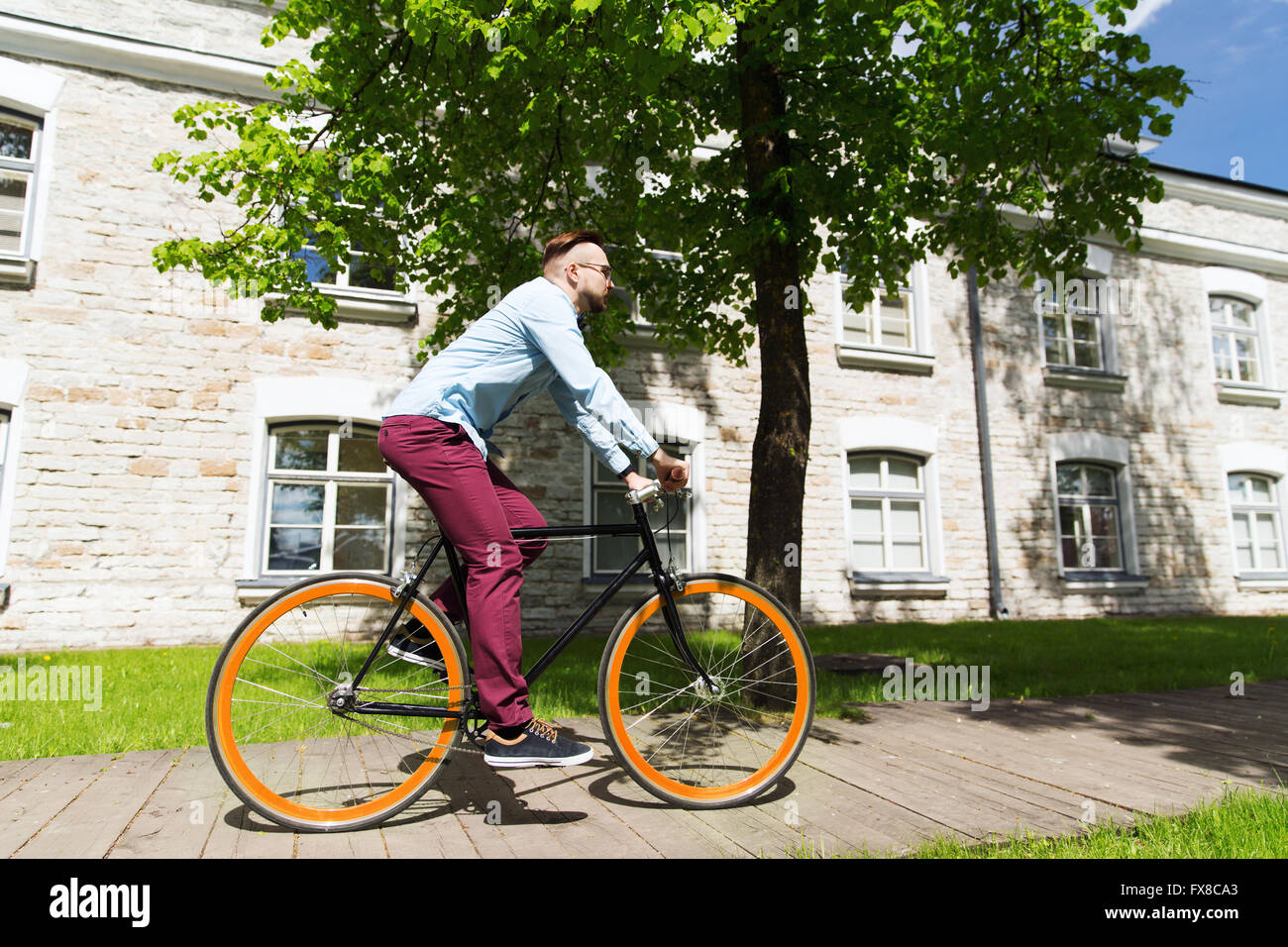 happy young hipster man riding fixed gear bike Stock Photo - Alamy