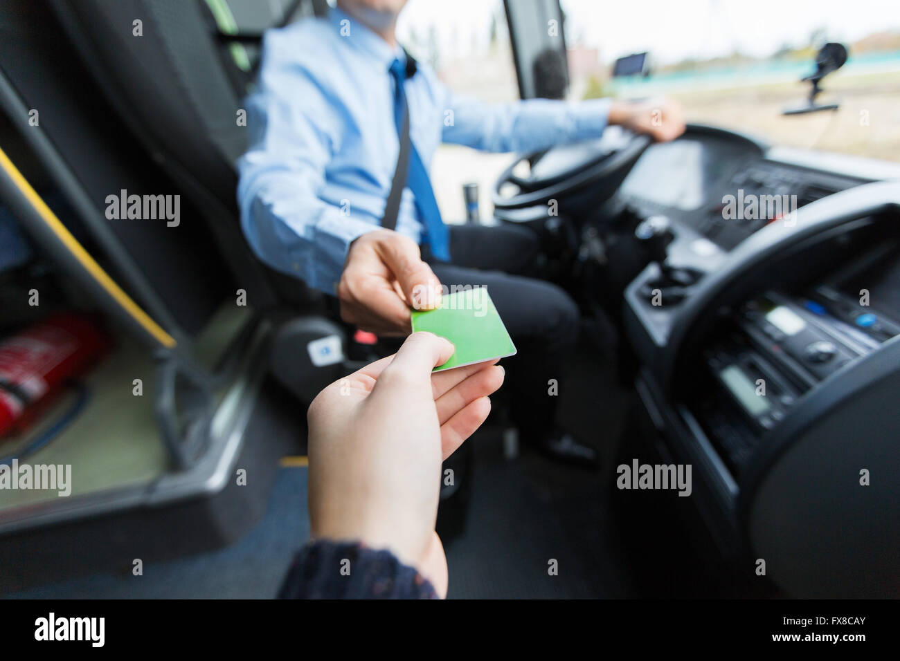 bus driver taking ticket or card from passenger Stock Photo - Alamy