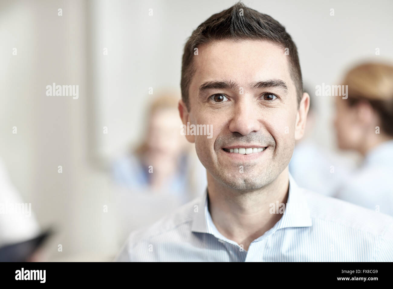 smiling businessman face in office Stock Photo - Alamy
