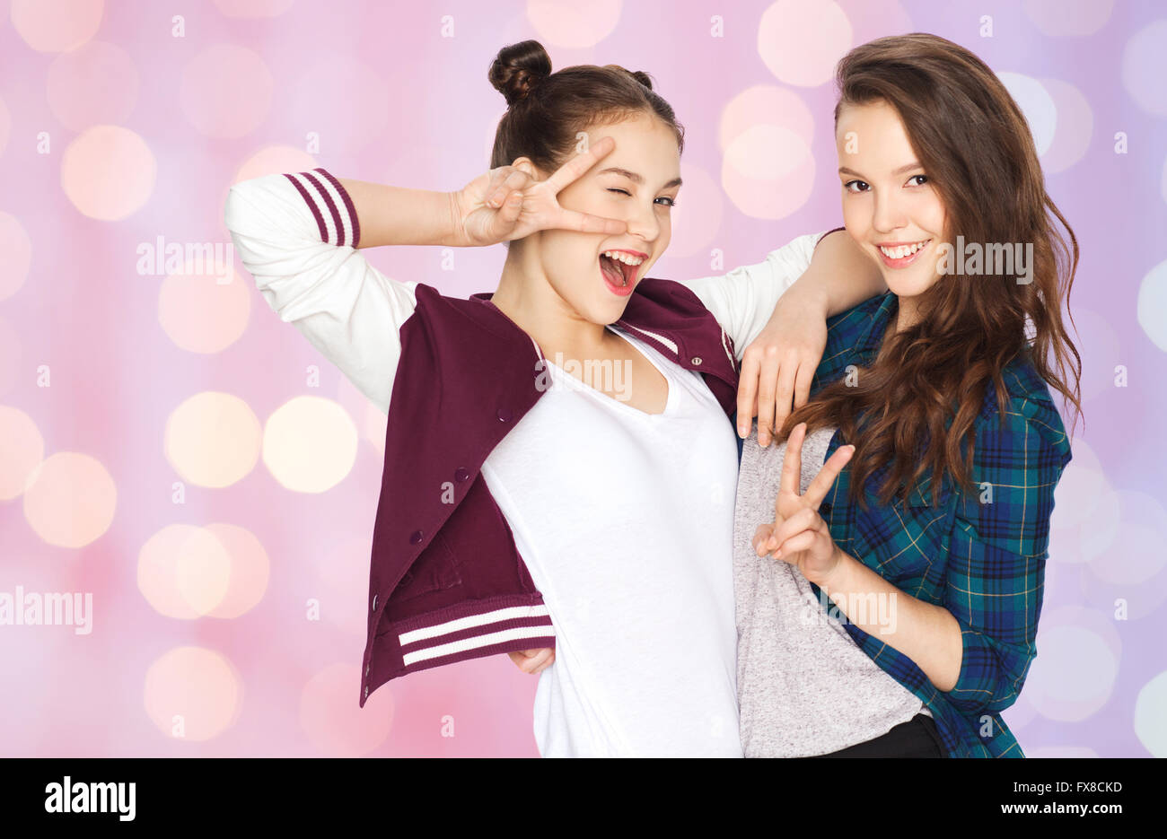 happy pretty teenage girls showing peace hand sign Stock Photo - Alamy