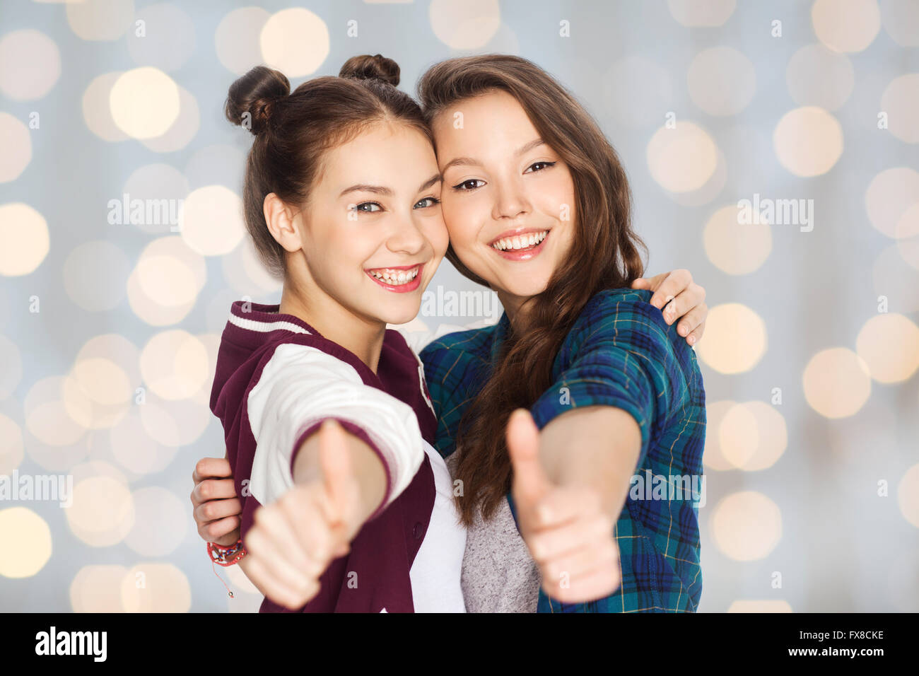 happy smiling teenage girls showing thumbs up Stock Photo - Alamy