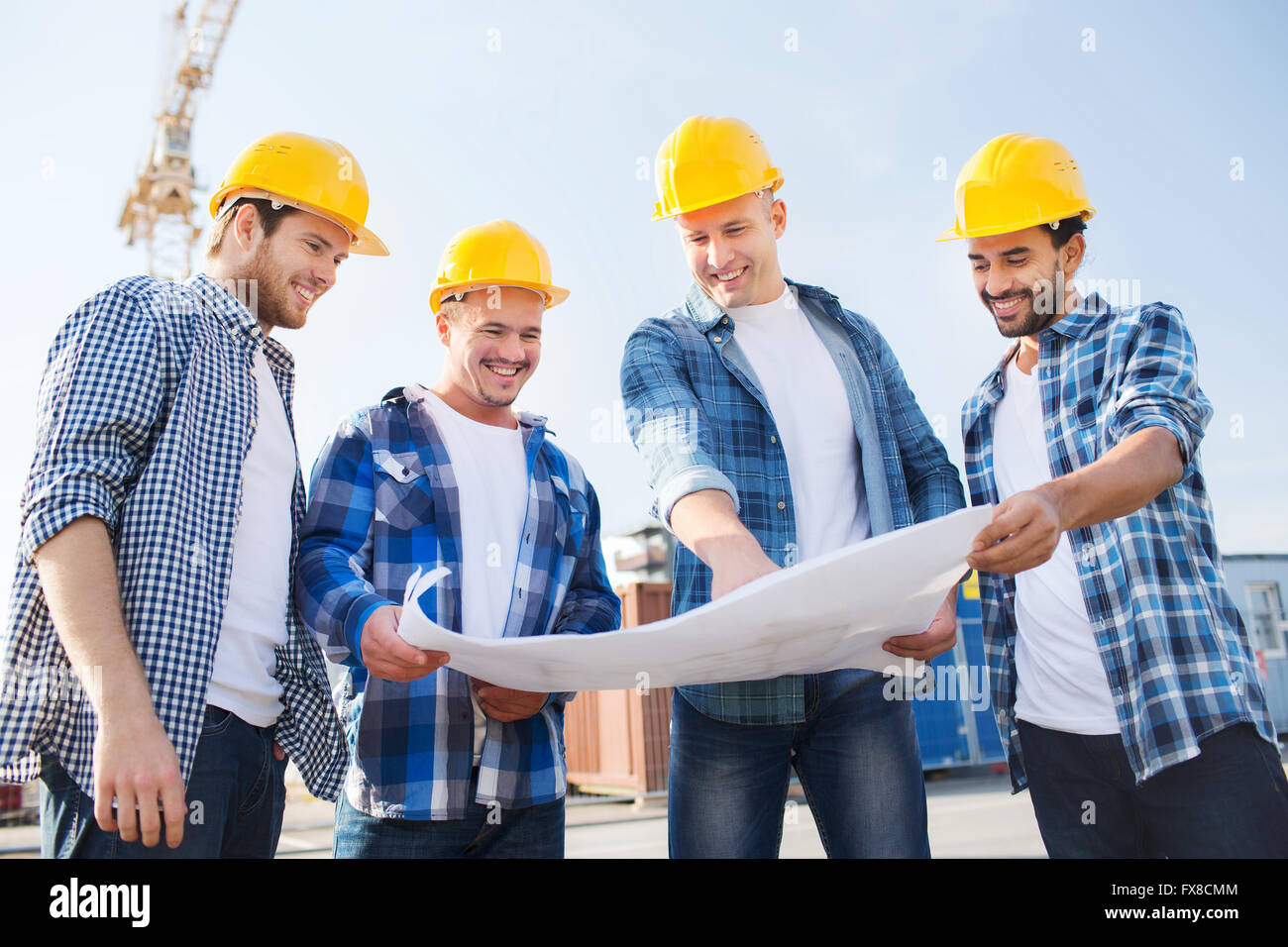 group of builders with tablet pc and blueprint Stock Photo - Alamy