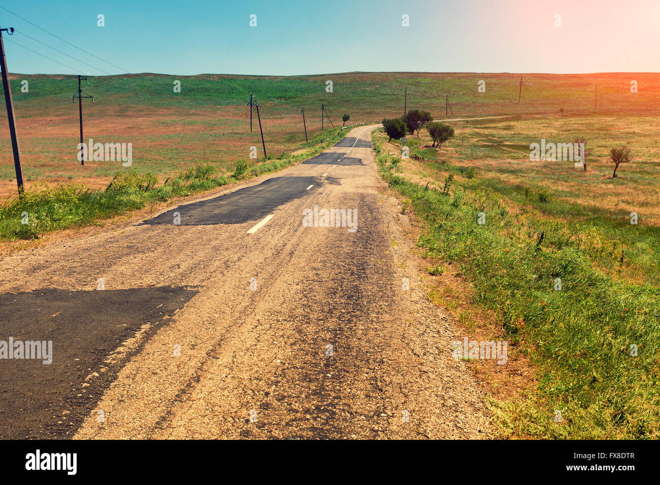 Paved road in the steppe with patches Stock Photo - Alamy