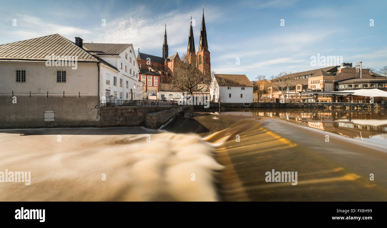 Old mill at Kvarnfallet in the Fyris river with the Uppsala Cathedral (Domkyrkan) in the ...