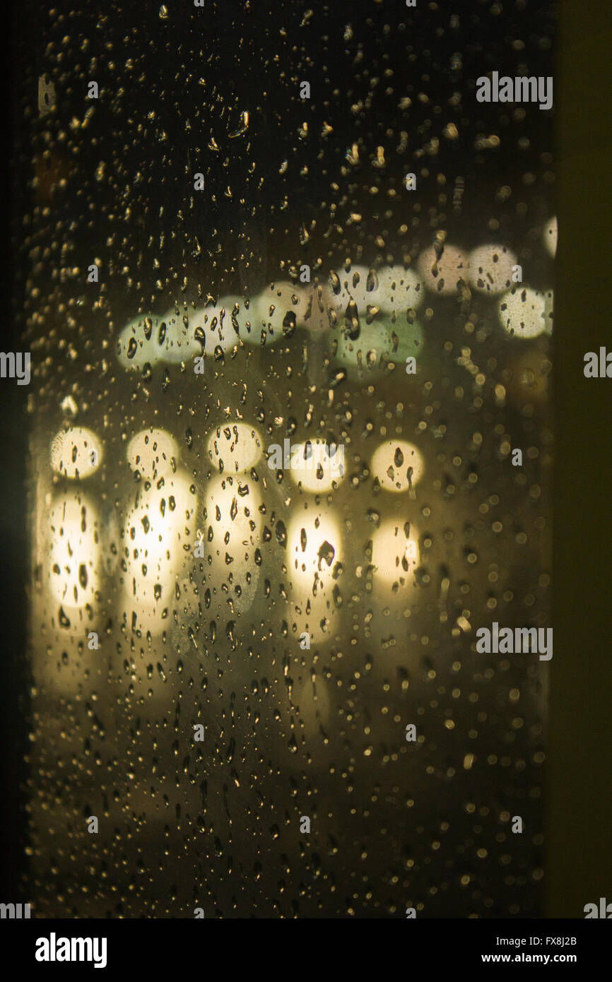 Lights through a window on a rainy night Stock Photo - Alamy